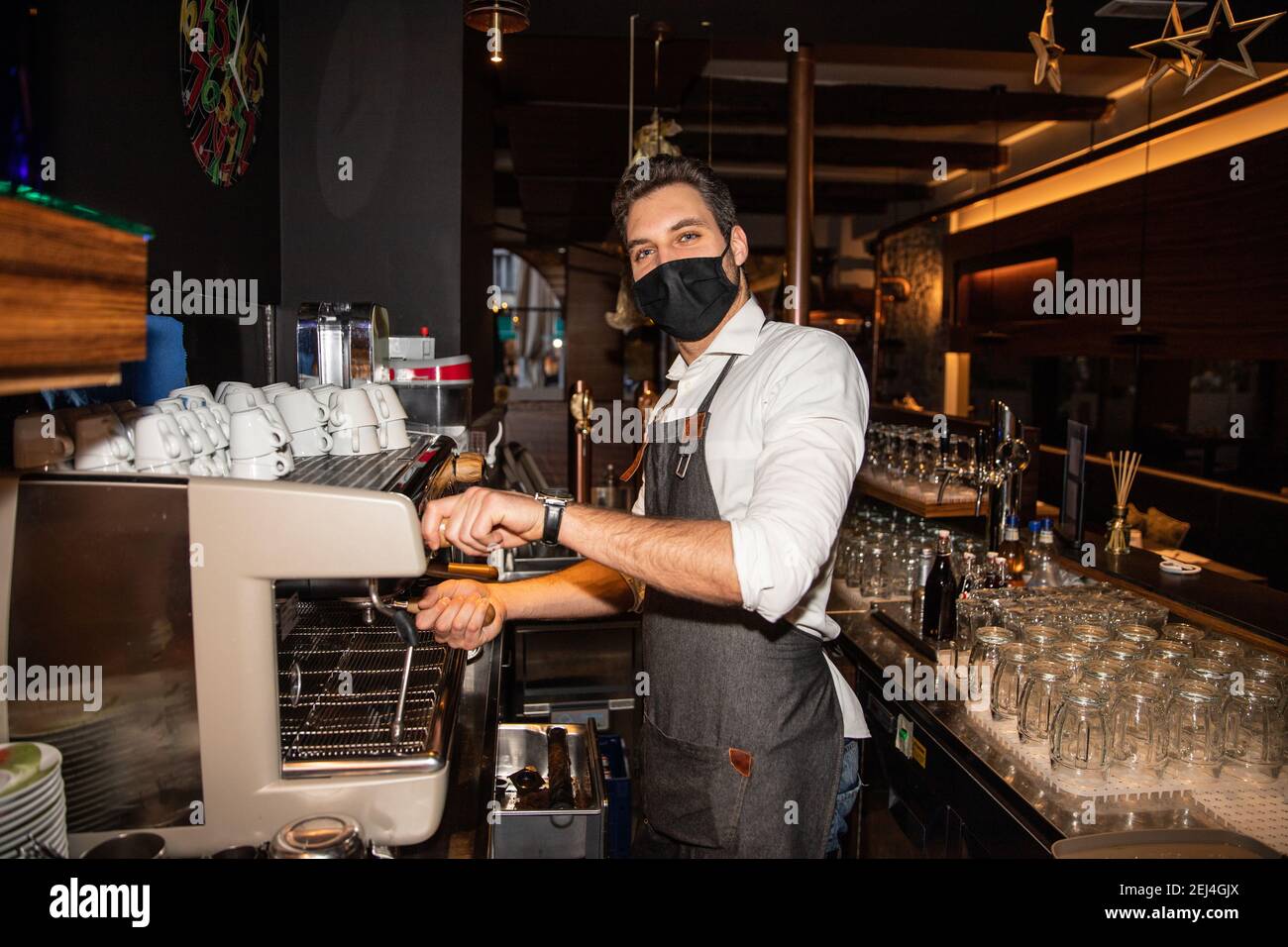 Bartender prepares a typical Italian coffee while working during the ...