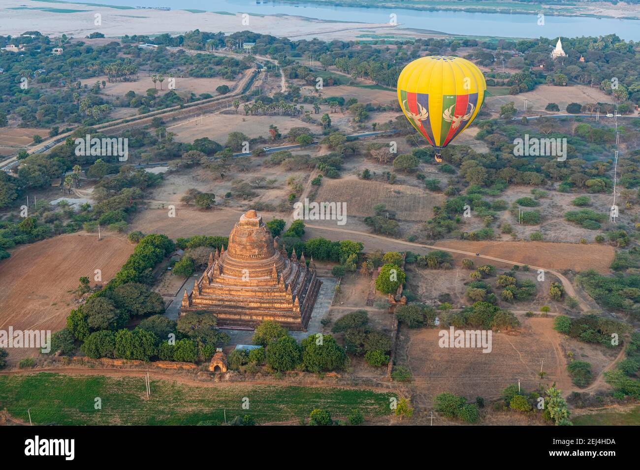 Hot air balloon at sunrise over a temple, Bagan, Myanmar Stock Photo ...