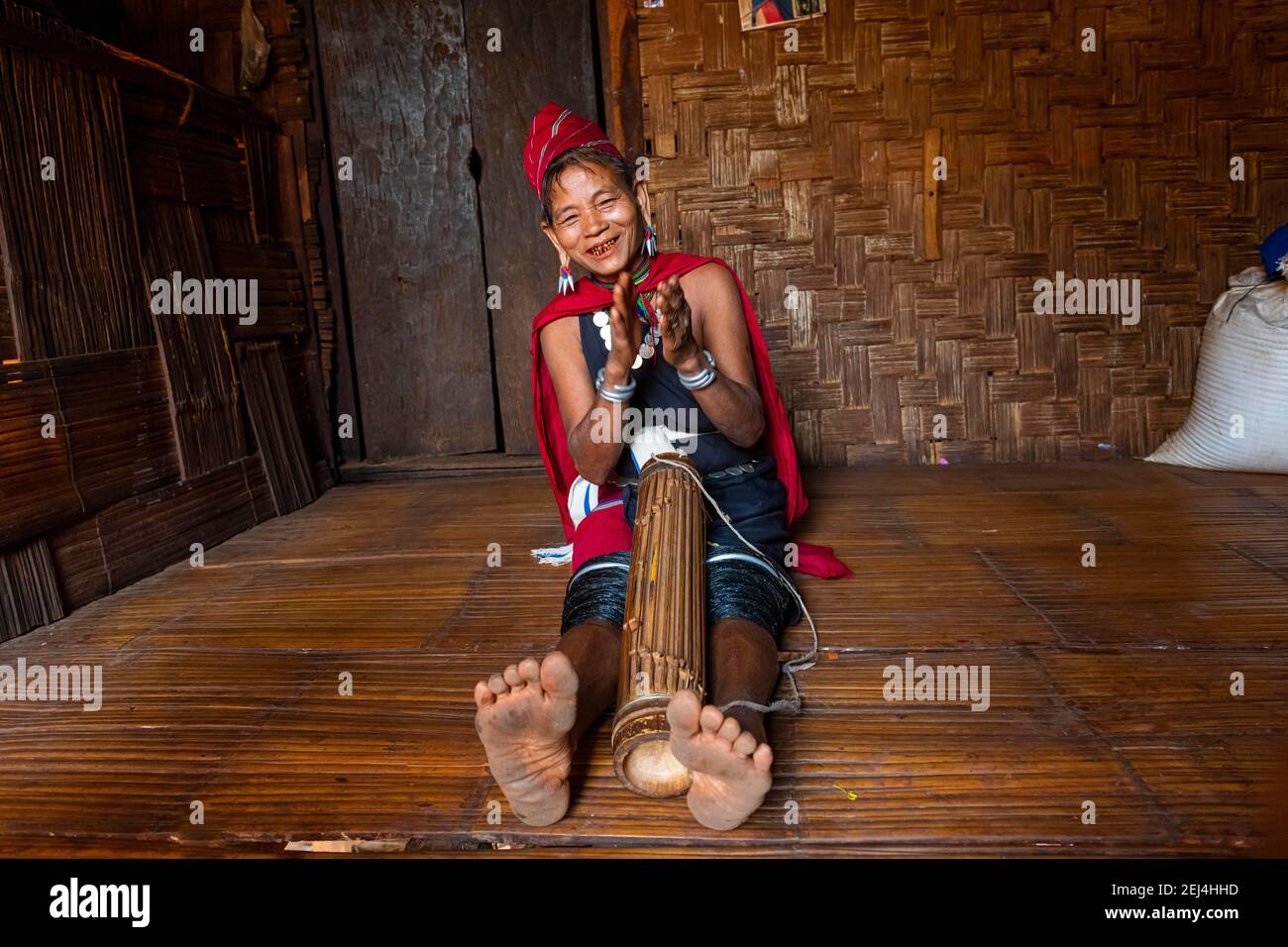 Old Kayah woman playing local instrument, Kayah village, Loikaw area ...