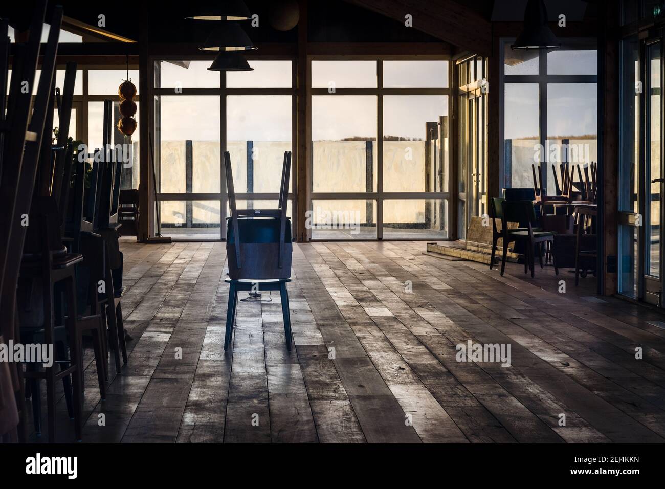 Empty beach pavilion with stacked chairs and empty spaces and terraces ...