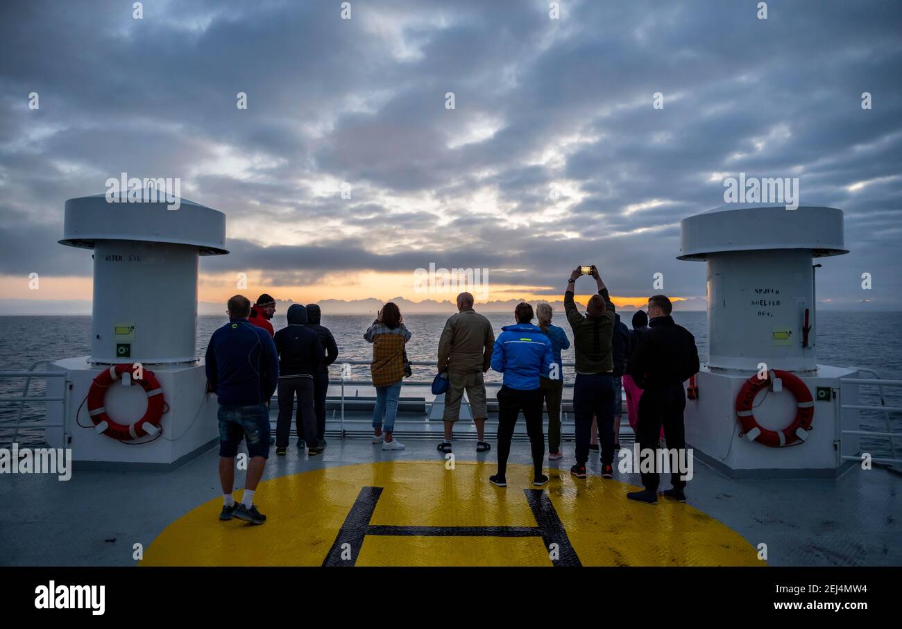 Passengers look out over the ocean, evening mood on the ferry to ...