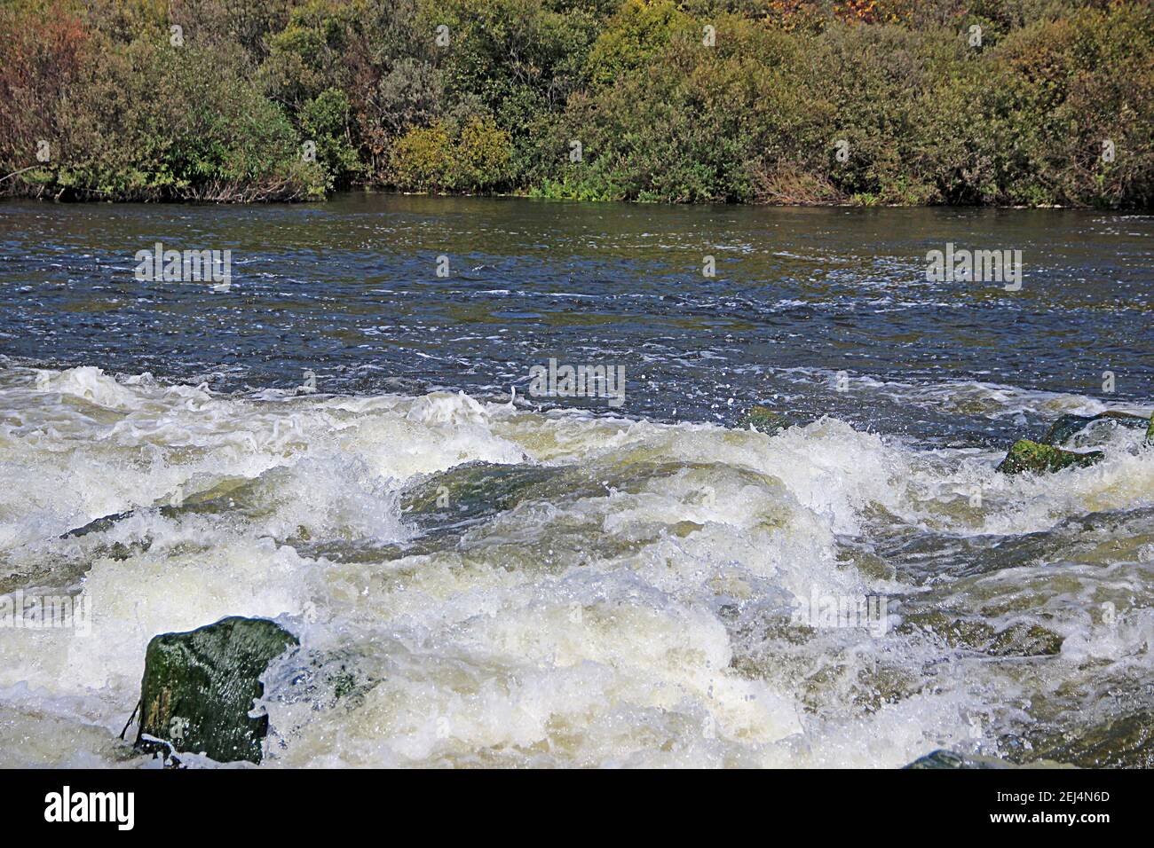 The mountain river flows over the rocks bubbling and foaming Stock ...