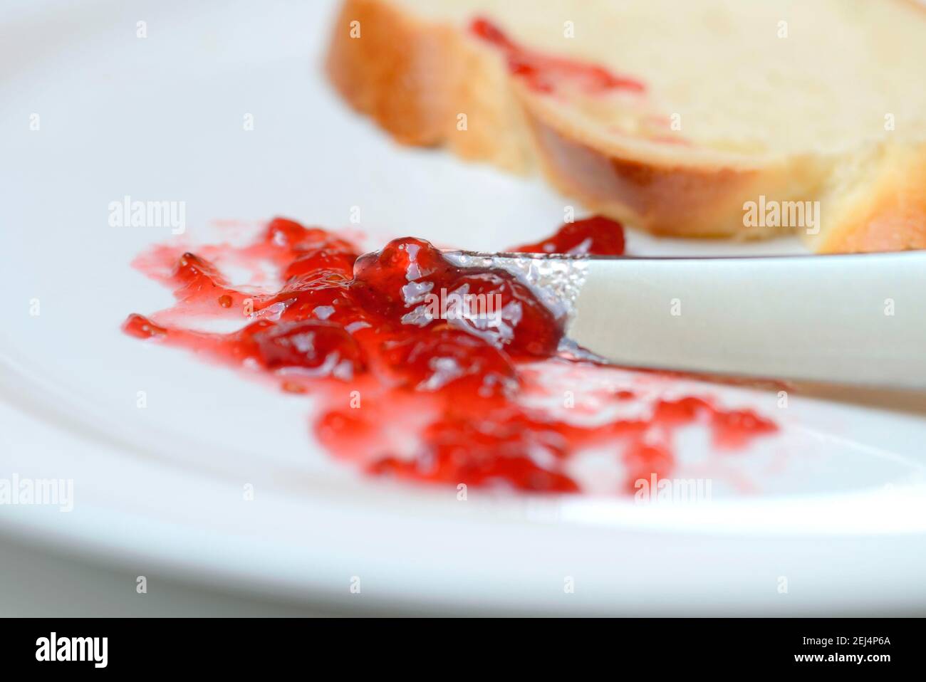 Jam and slice of braided butter, raspberry jam Stock Photo - Alamy