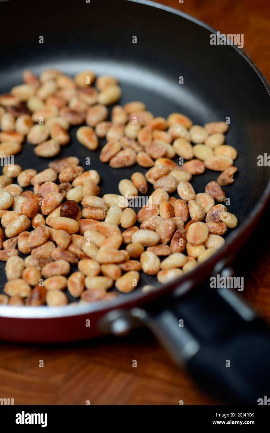 Roasted seeds ( Pinus pinea) in frying pan Stock Photo - Alamy