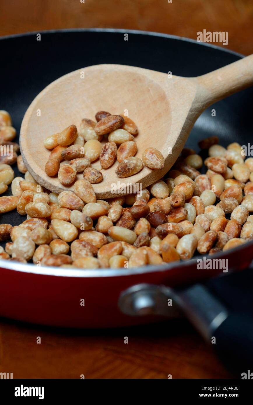 Roasted seeds ( Pinus pinea) in frying pan Stock Photo - Alamy