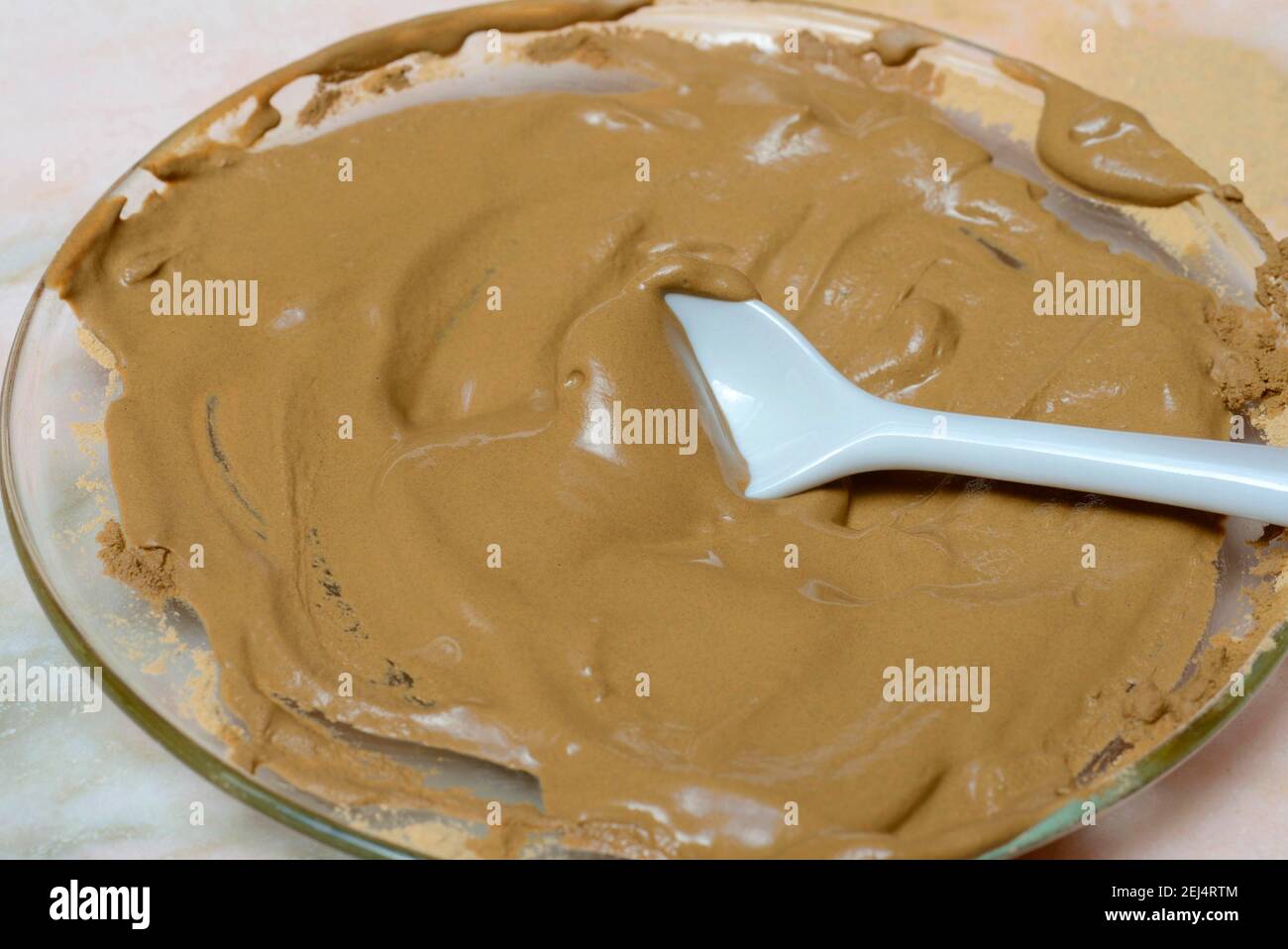 Red clay mixed with water, clay, healing earth powder Stock Photo - Alamy