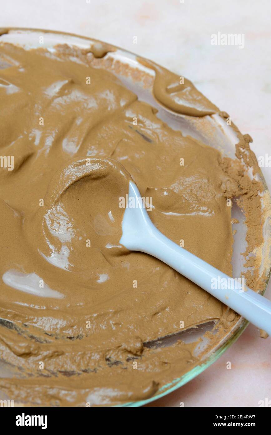 Red clay mixed with water, clay, healing earth powder Stock Photo - Alamy