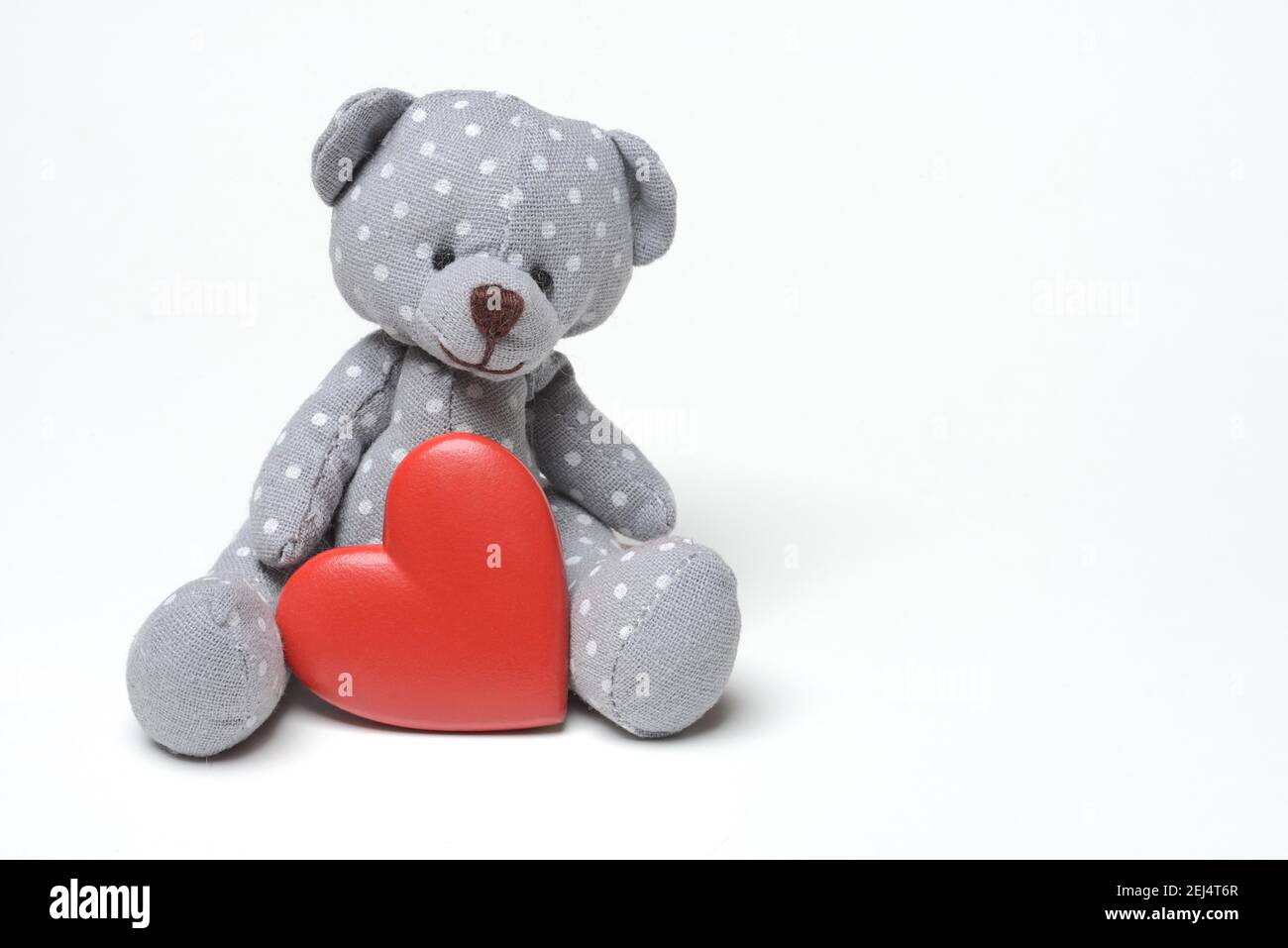 Teddy bear with red heart Stock Photo - Alamy