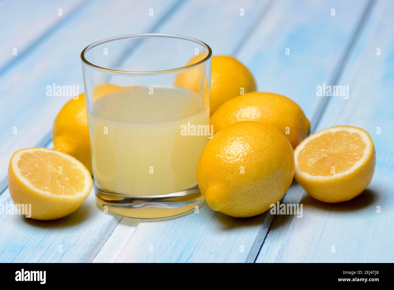 Glass of lemon juice with lemons Stock Photo - Alamy