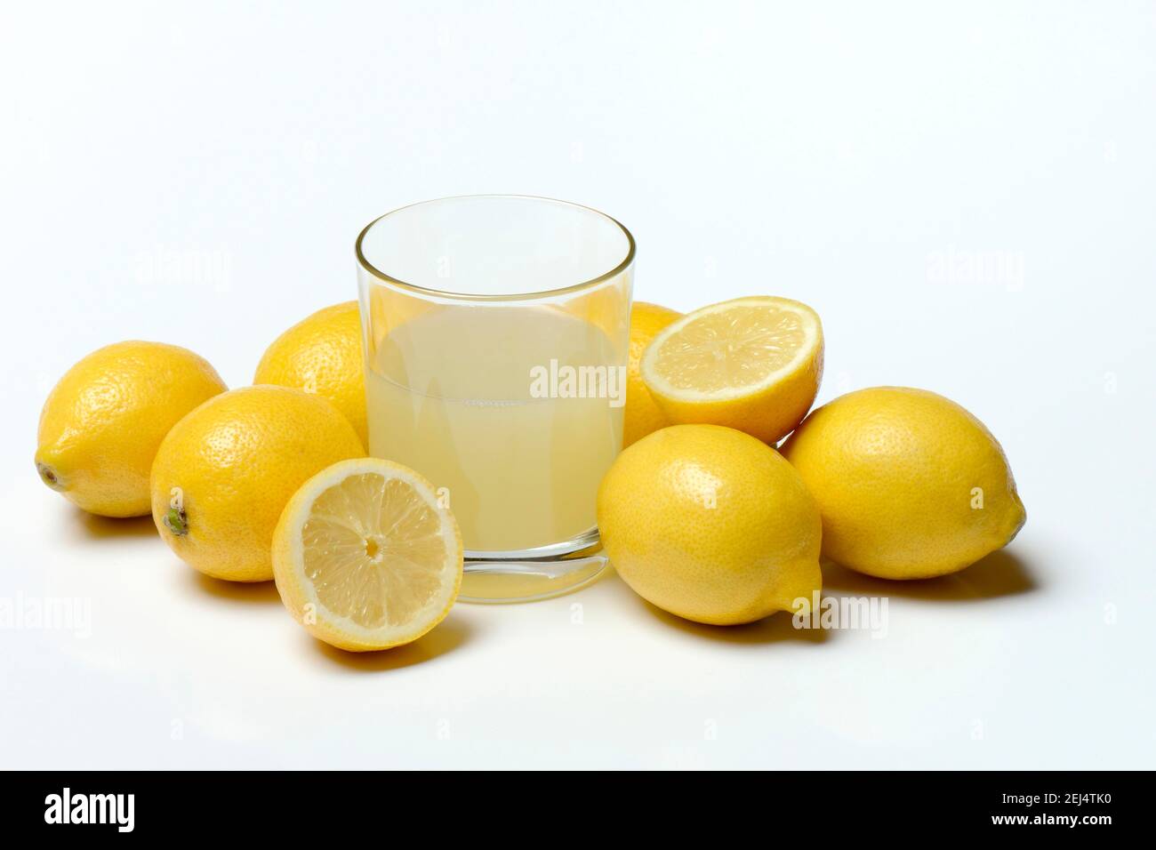 Glass of lemon juice with lemons Stock Photo - Alamy