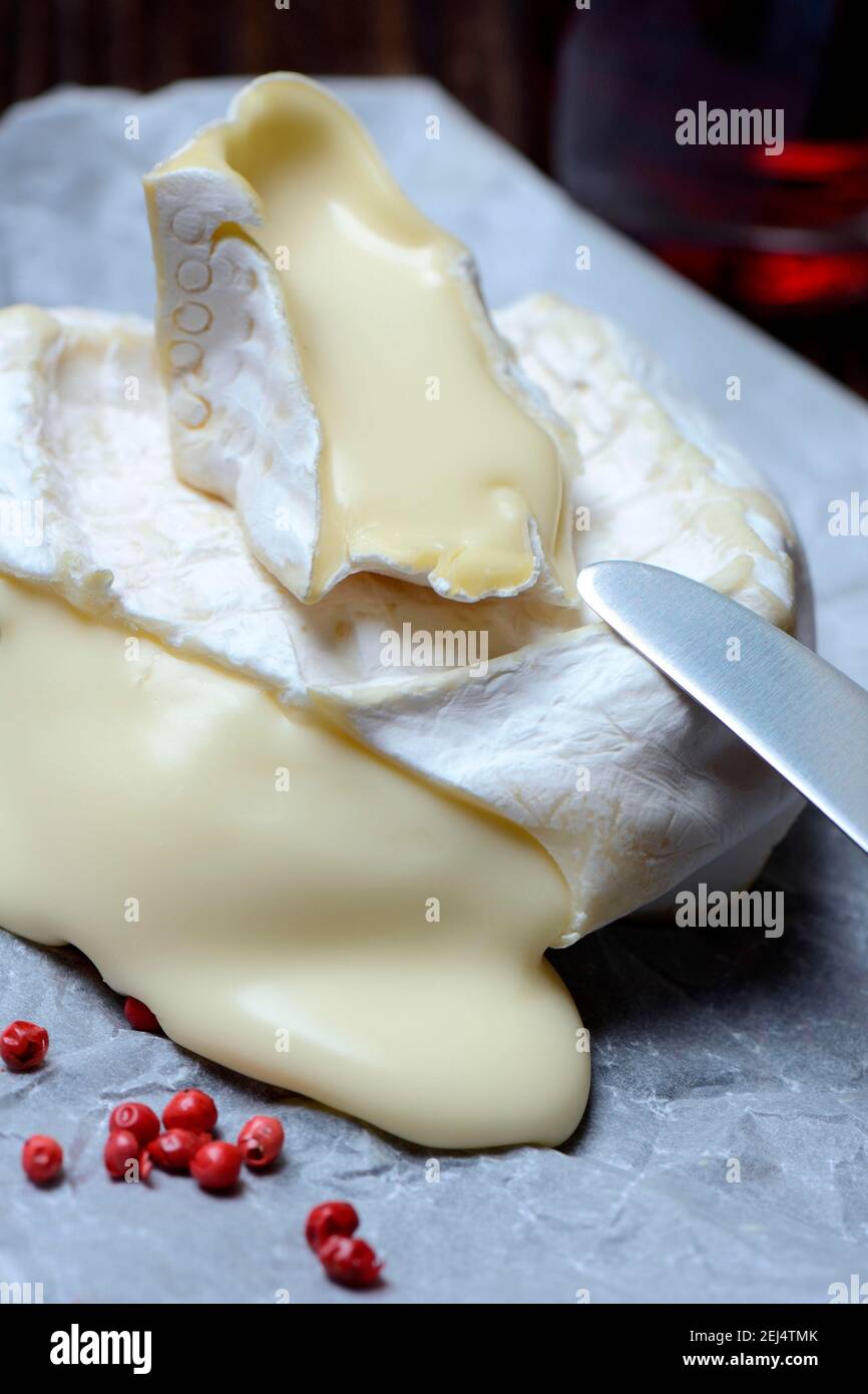 French soft cheese, Pave d'affinois, cut, sliced Stock Photo - Alamy
