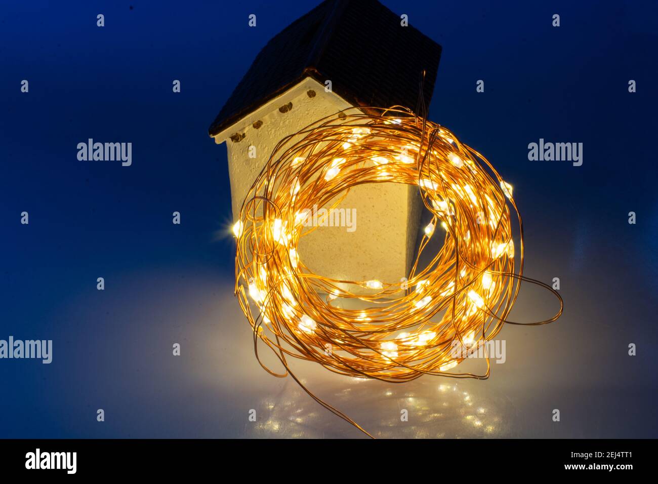 Small decorative model houses in christmas lights Stock Photo - Alamy