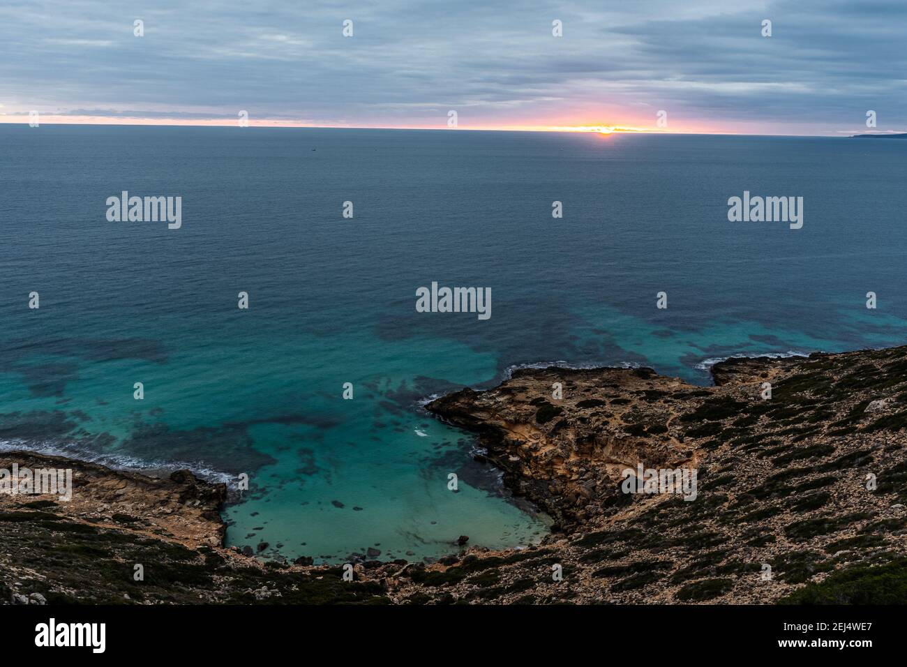 Beautiful sunset view of Cala Vella, a small cove on the cliffs of ...
