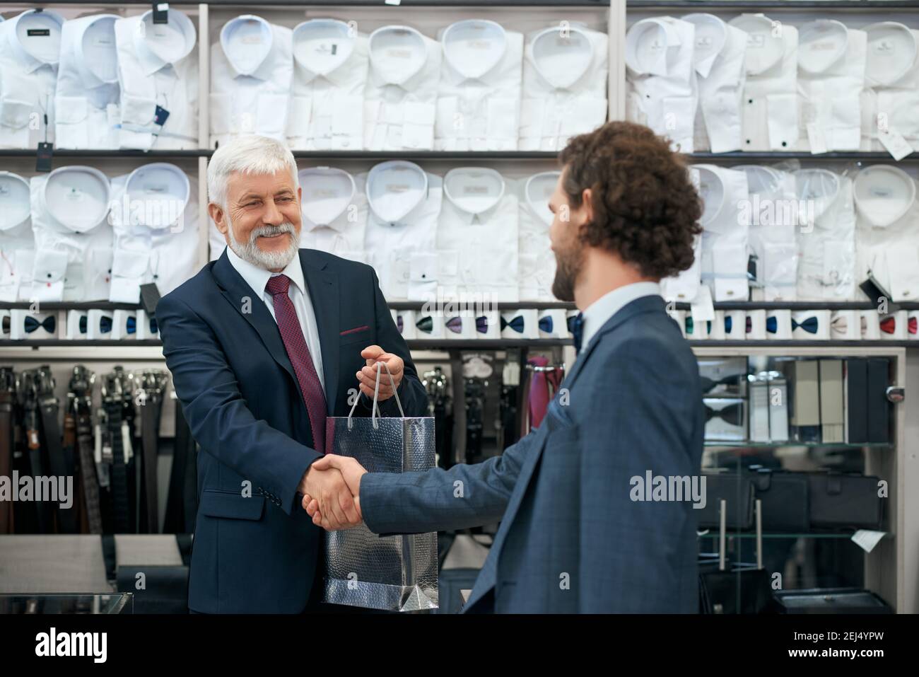 Happy client making purchase in store with style costumes. Concept of ...