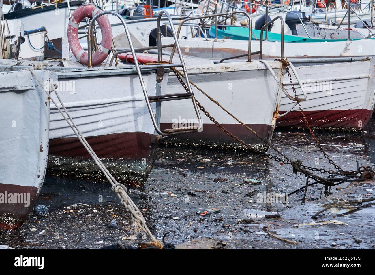 environmental pollution - extremely dirty water between moored ships in ...