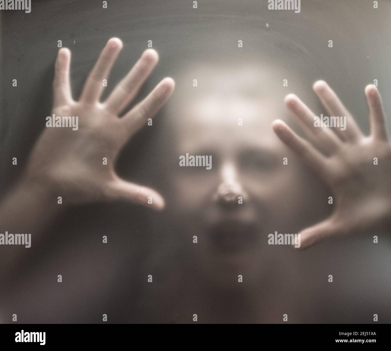 Scary picture of hands behind glass Stock Photo - Alamy