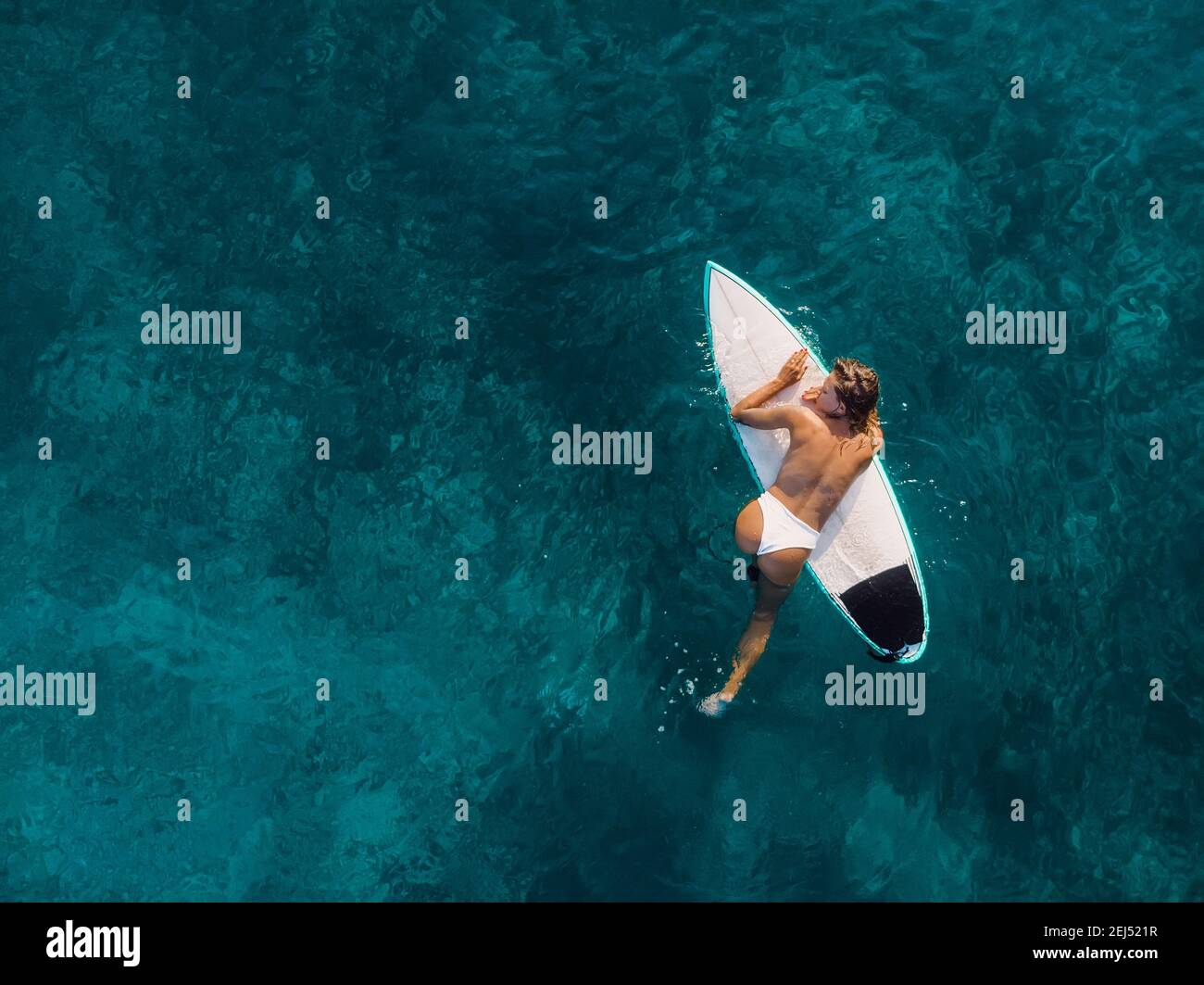 Surfer girl relaxing on surfboard hi-res stock photography and images ...