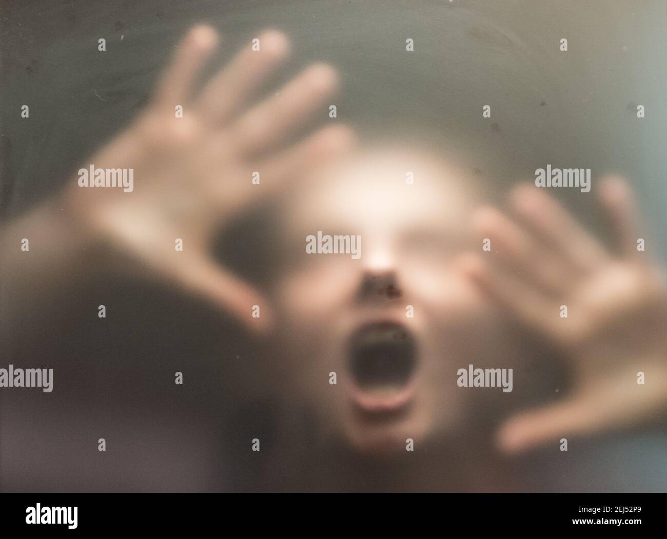 Scary picture of hands behind glass Stock Photo - Alamy