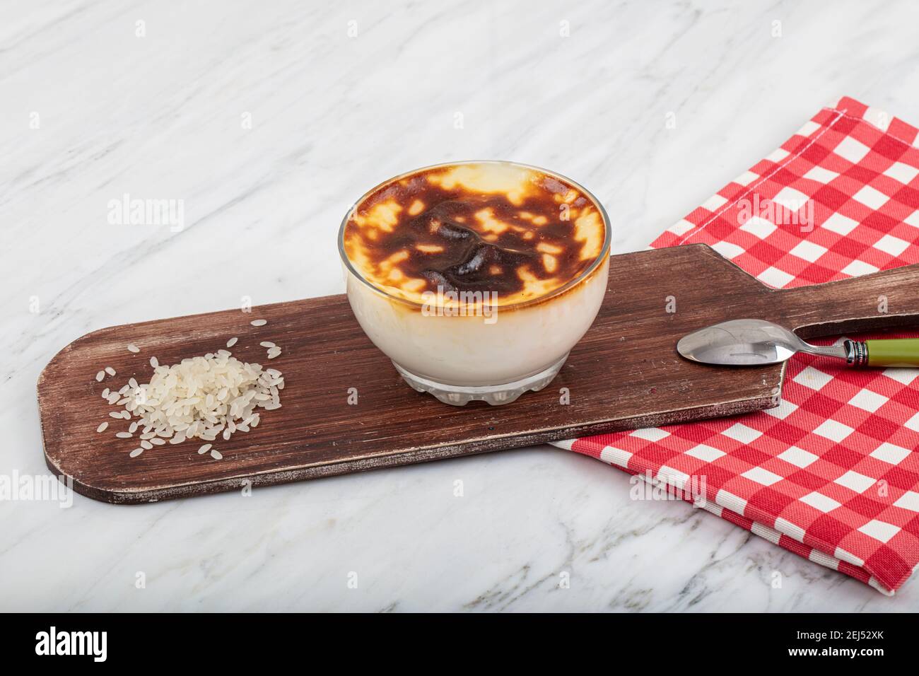 Traditional Turkish oven rice pudding in a glass bowl. marble ...