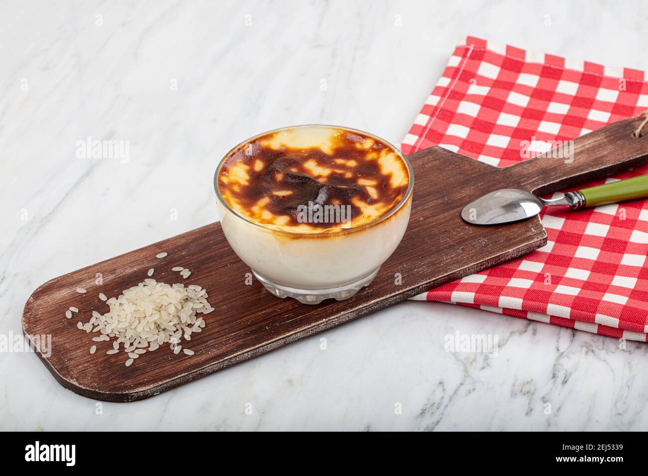Traditional Turkish oven rice pudding in a glass bowl. marble ...