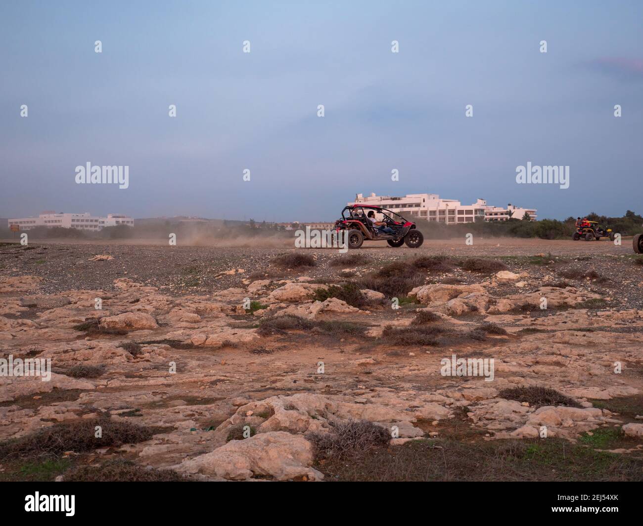 High-speed fast off-road buggy cars racing at waste land with big rocks ...