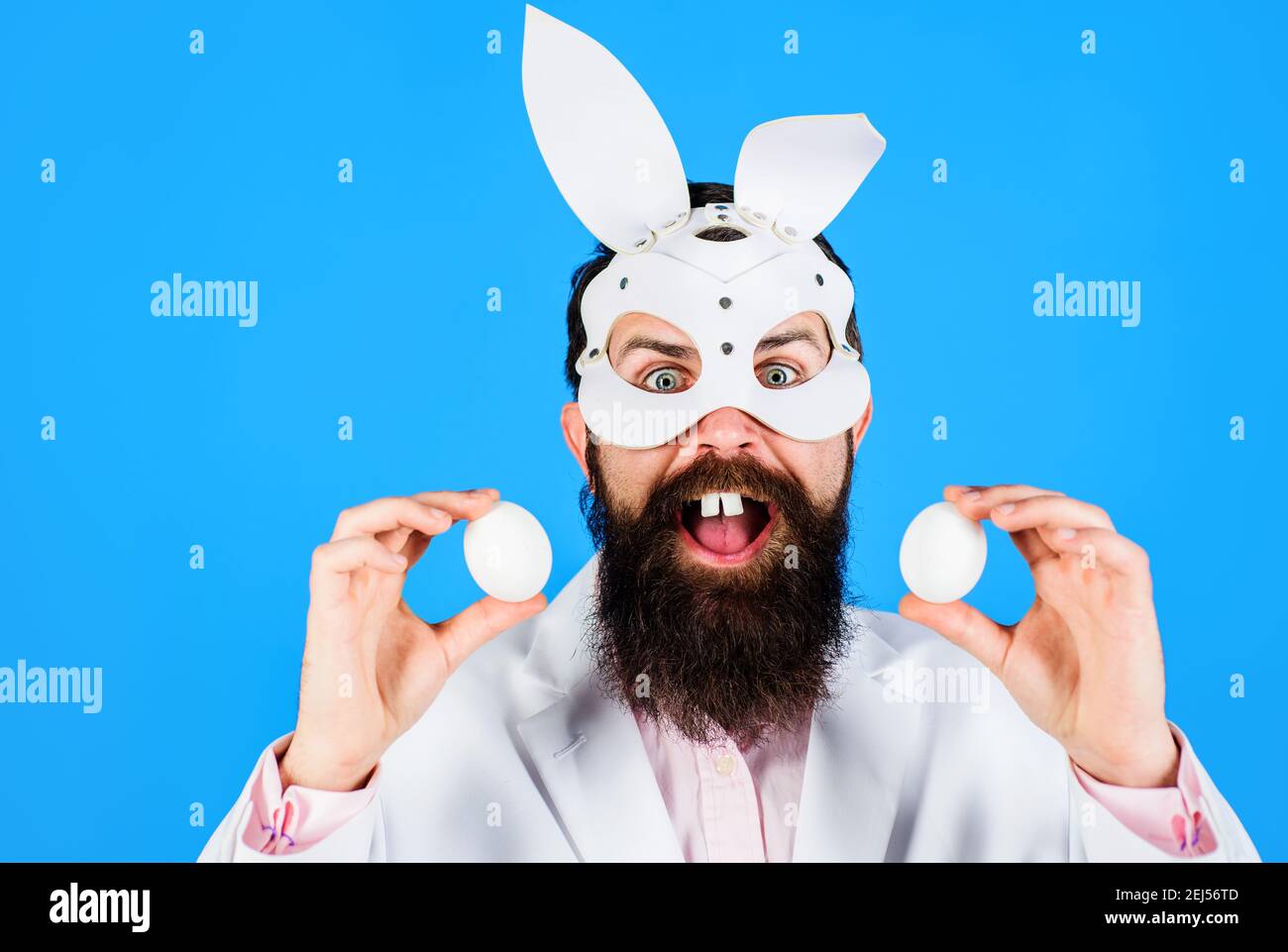 Funny Easter man with white eggs. Egg hunt. Easter bunny guy with ...