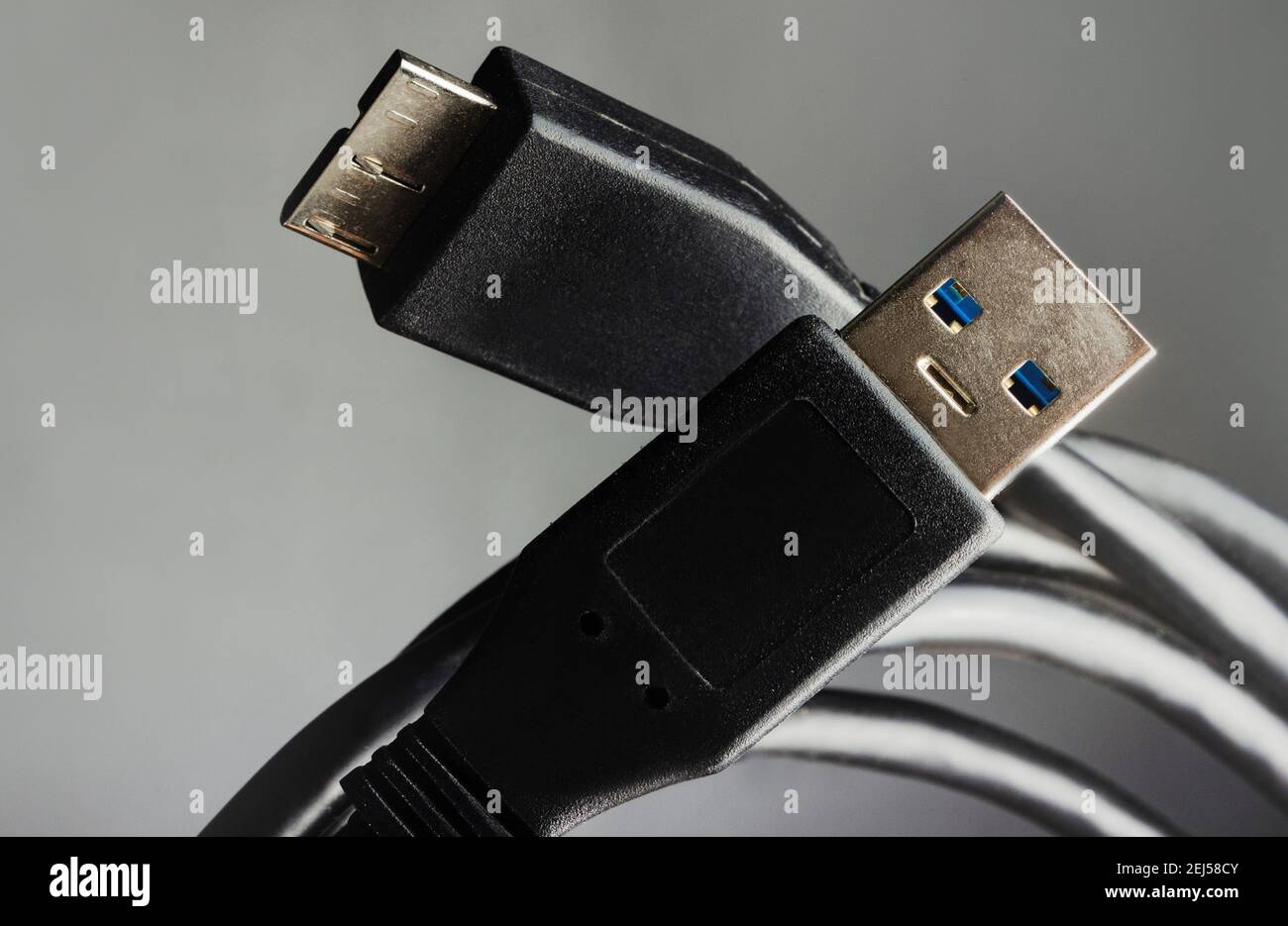 Close-up photo of black usb cables on grey background Stock Photo - Alamy