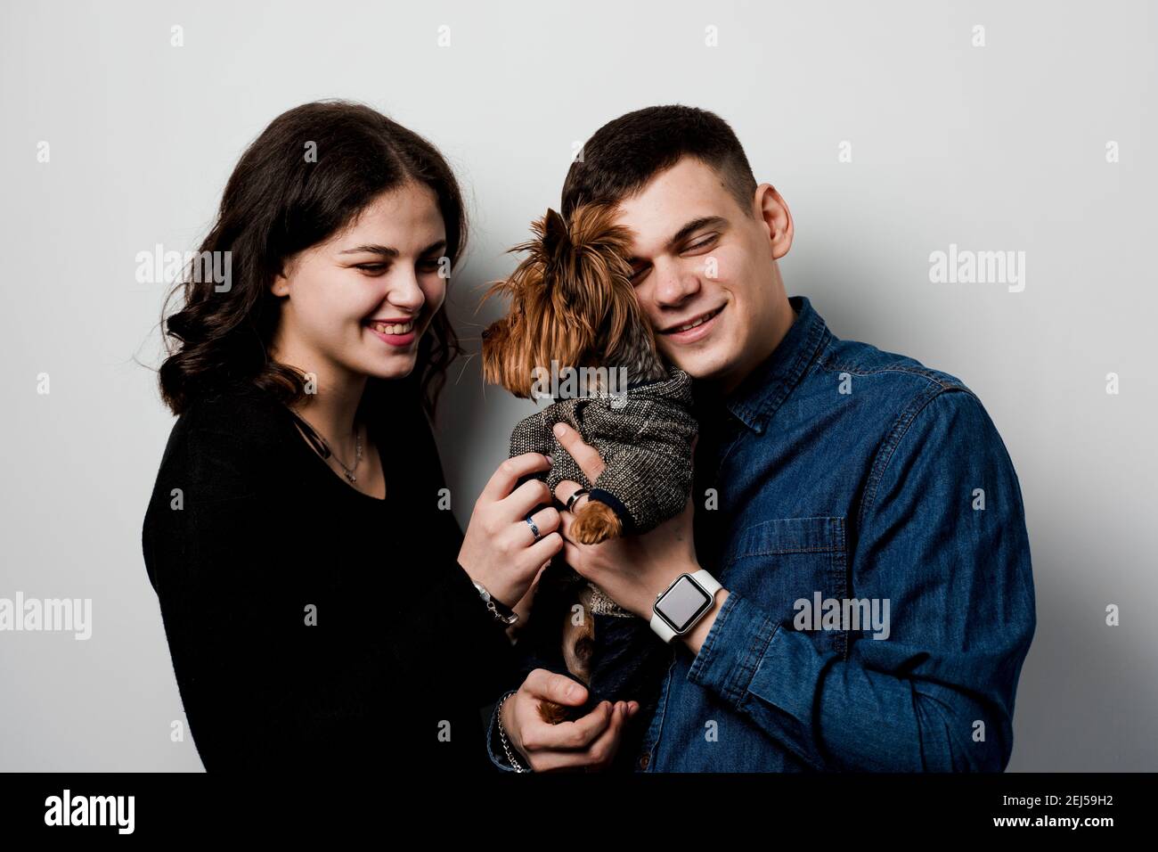 Yorkshire terrier with lovely couple on white background. Happy family ...