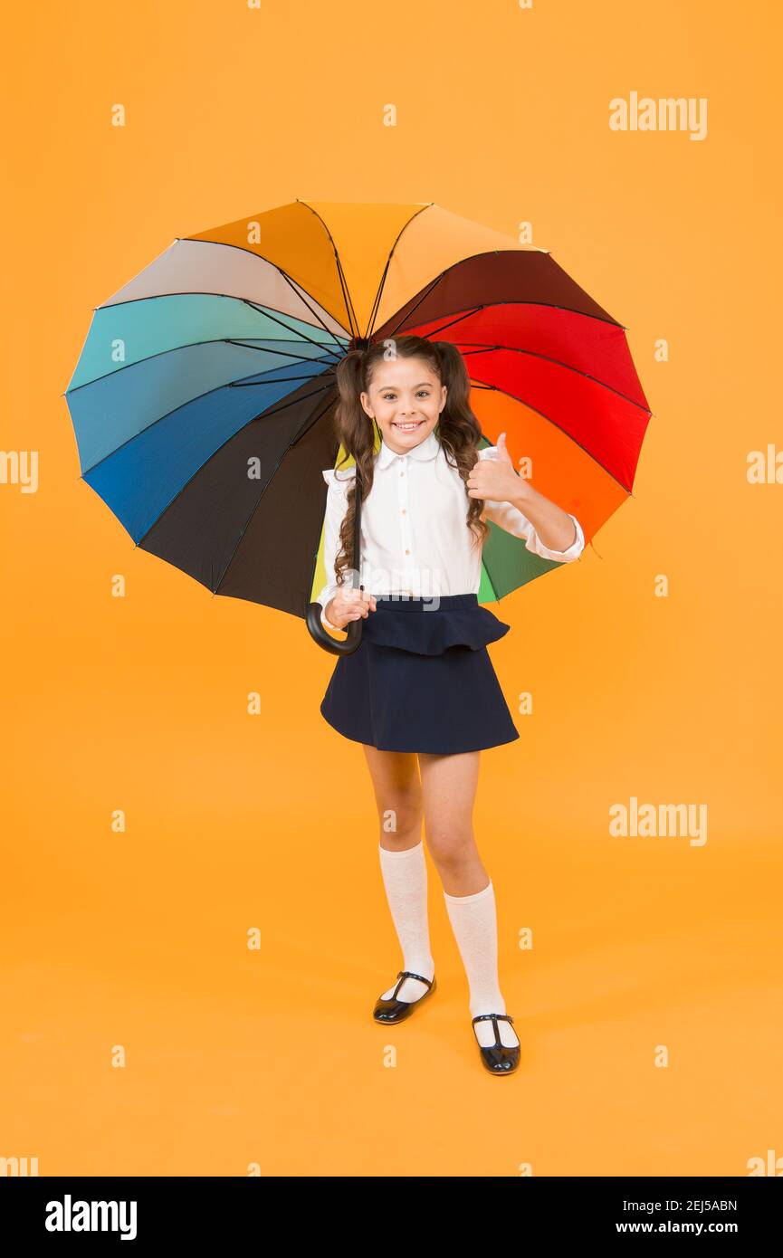 Everything under control. Fancy schoolgirl. Girl with umbrella. Rainy day. Happy childhood ...