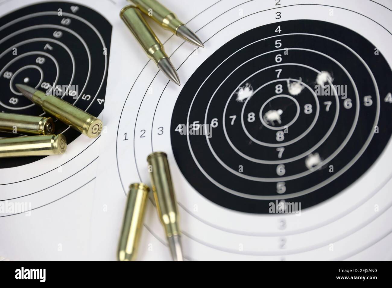 Many bullets with shooting targets on white table in shooting range ...