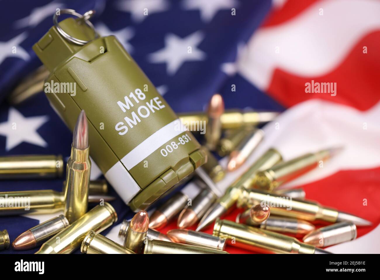 M18 smoke grenade and many yellow bullets and cartridges on United ...