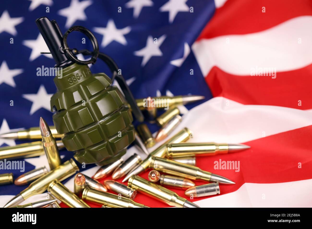 F1 frag grenade and many yellow bullets and cartridges on United States ...