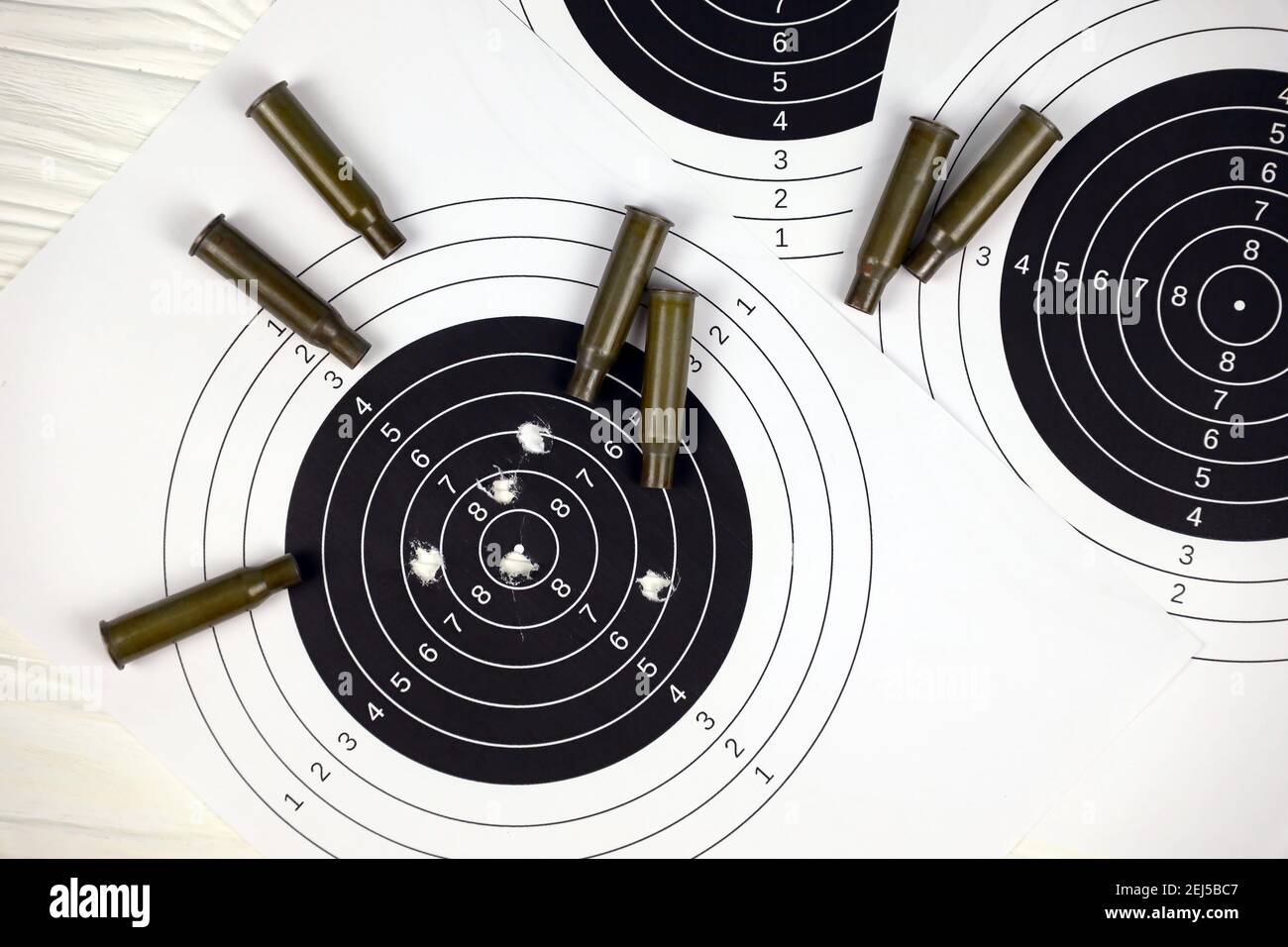 Many bullets with shooting targets on white table in shooting range ...