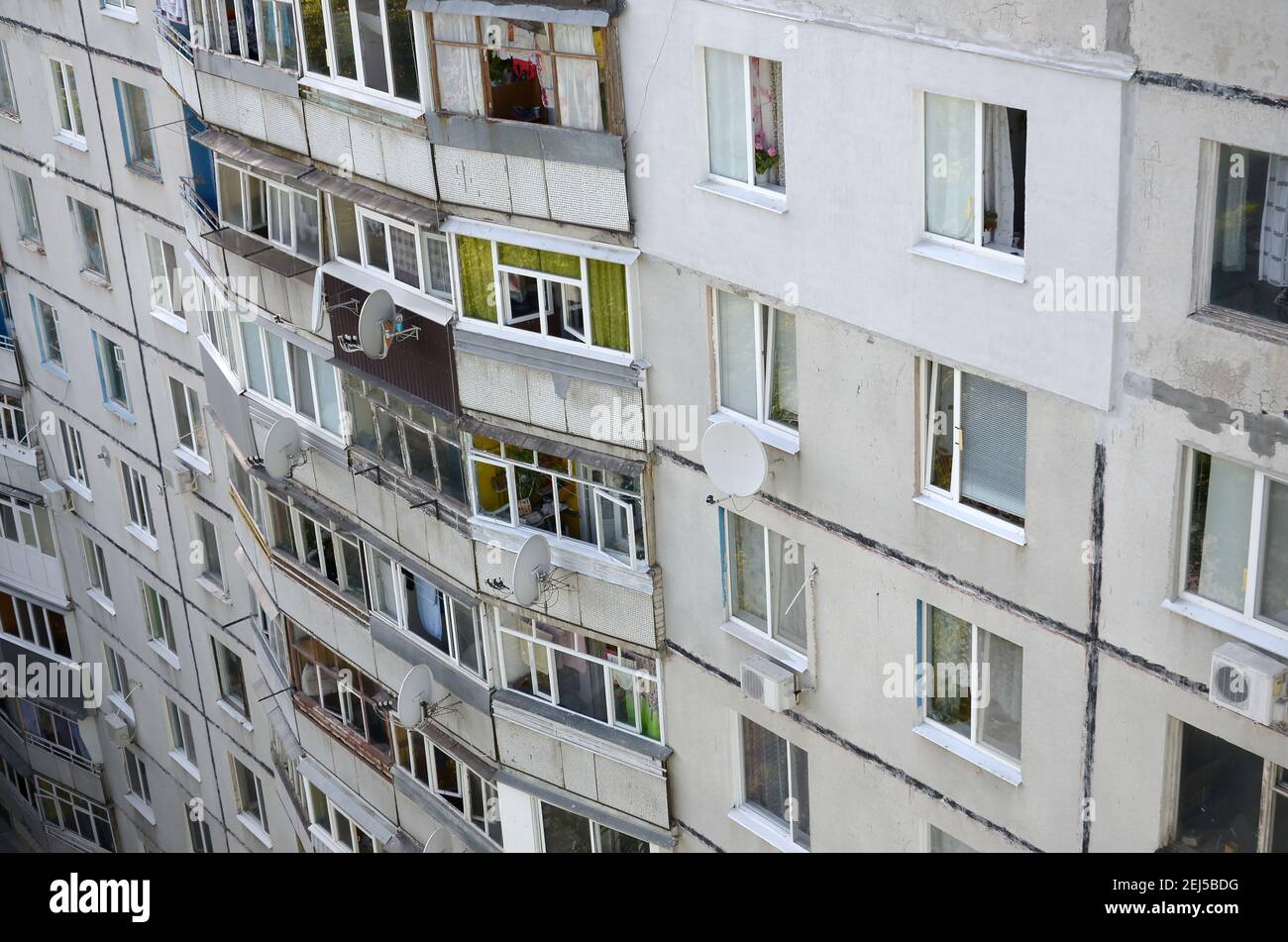 Facade of a grey multi storey soviet panel building. Russian old urban ...
