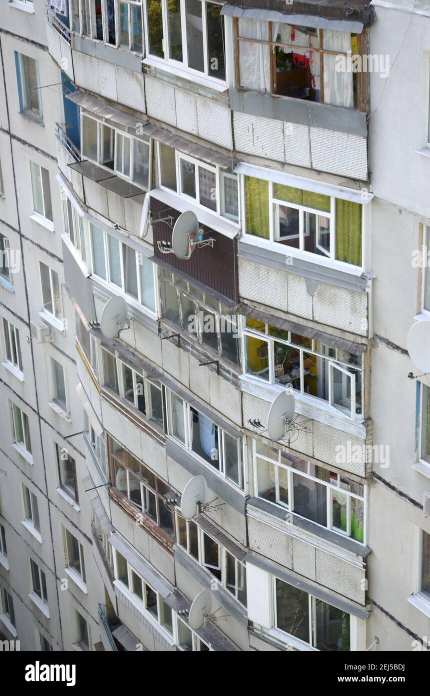 Facade of a grey multi storey soviet panel building. Russian old urban ...