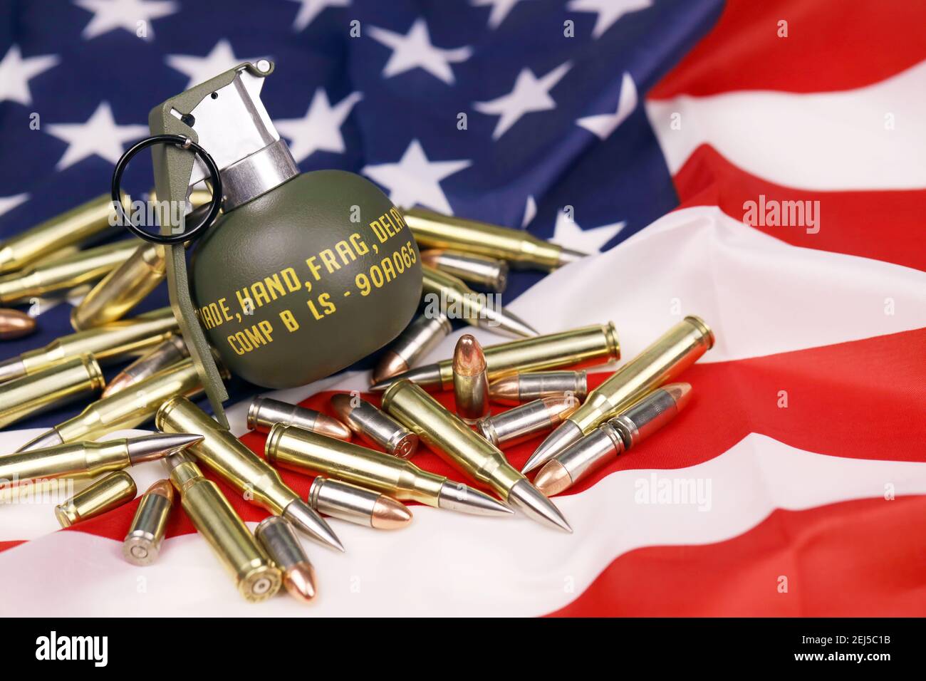 M67 frag grenade and many yellow bullets and cartridges on United ...