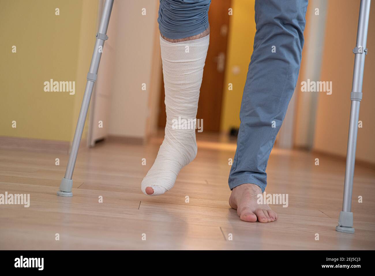 A man on crutches. Young man with a broken leg Stock Photo - Alamy