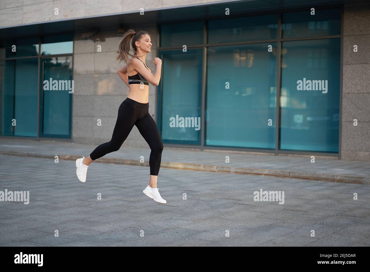 Woman running urban city street background Active sporty caucasian ...