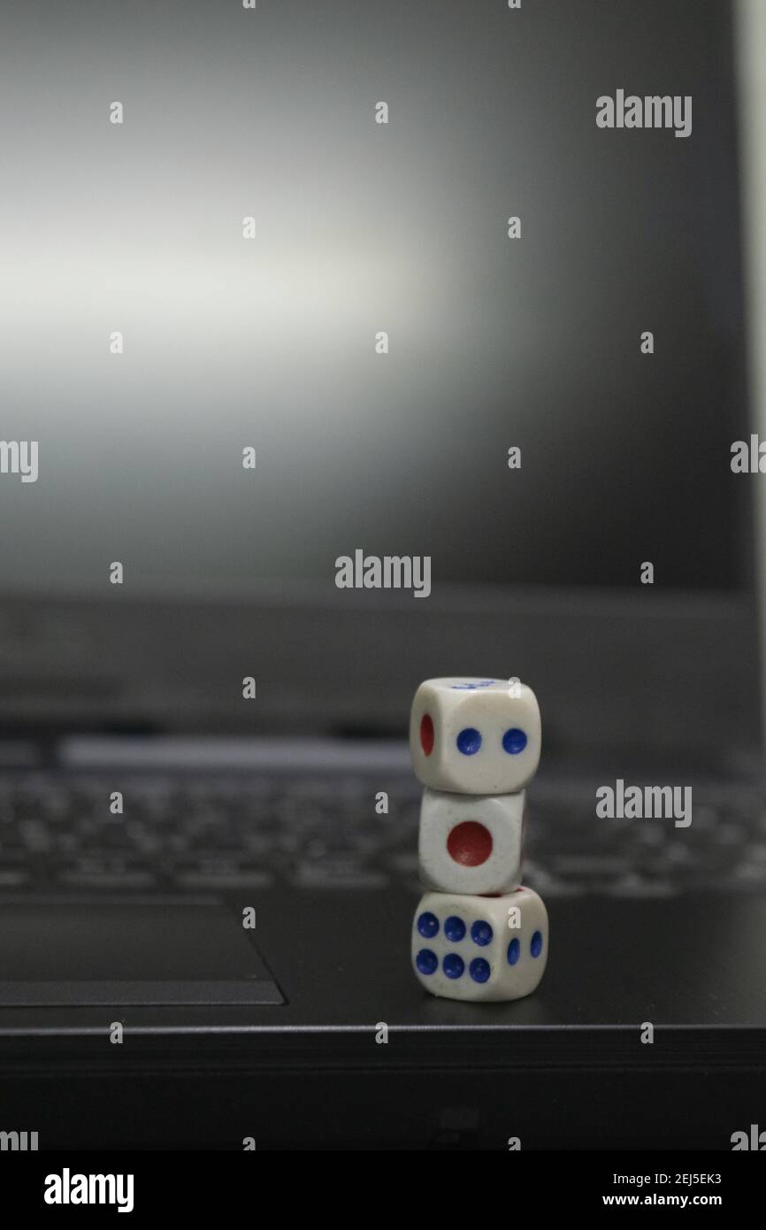 A vertical shot of dice on a grayscale background Stock Photo - Alamy
