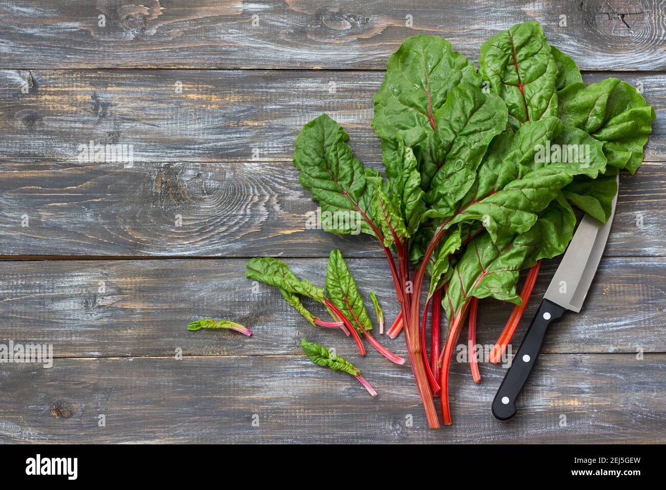 Fresh raw leaves of chard, leaf beets, mangold, swiss chard on a wooden ...