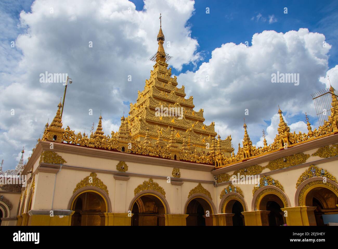 A beautiful cloudscape over golden Mahamuni Buddha Temple in Mandalay ...