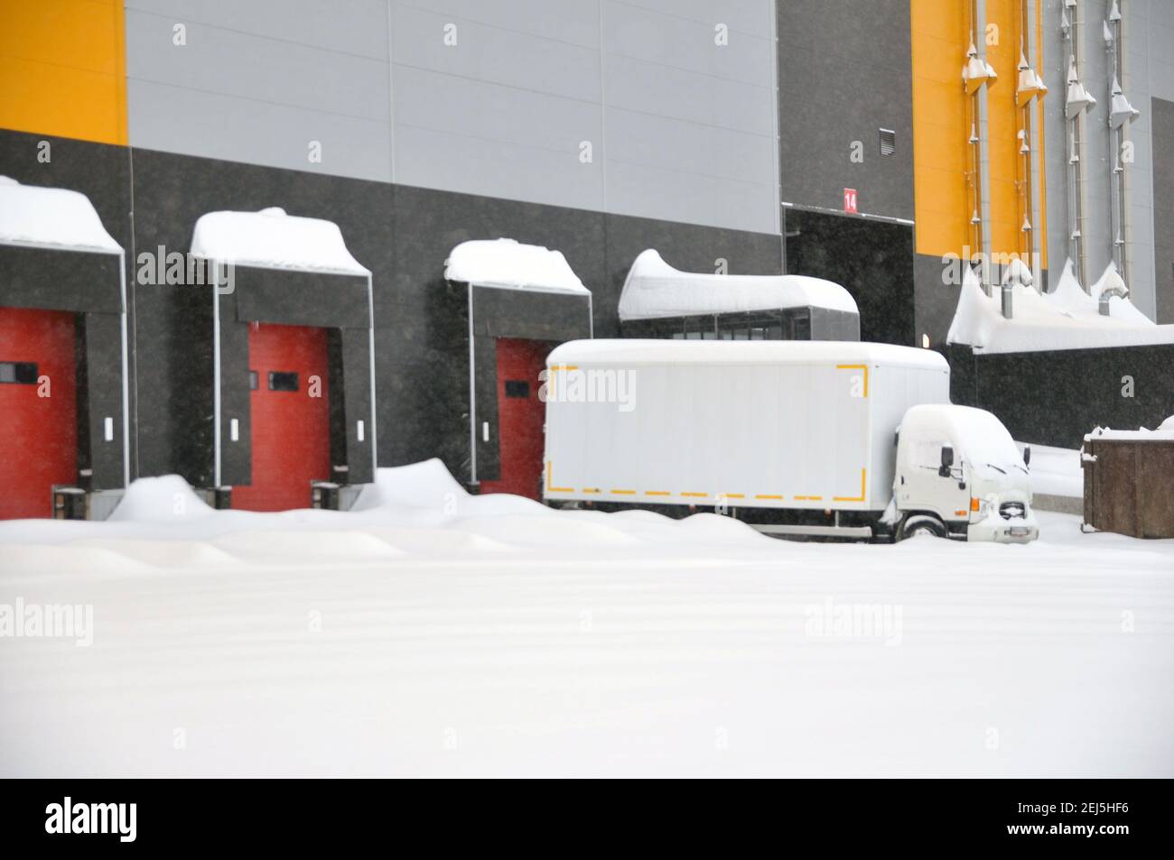 Heavy snowfall. Delivery of goods to the warehouse logistics complex is ...