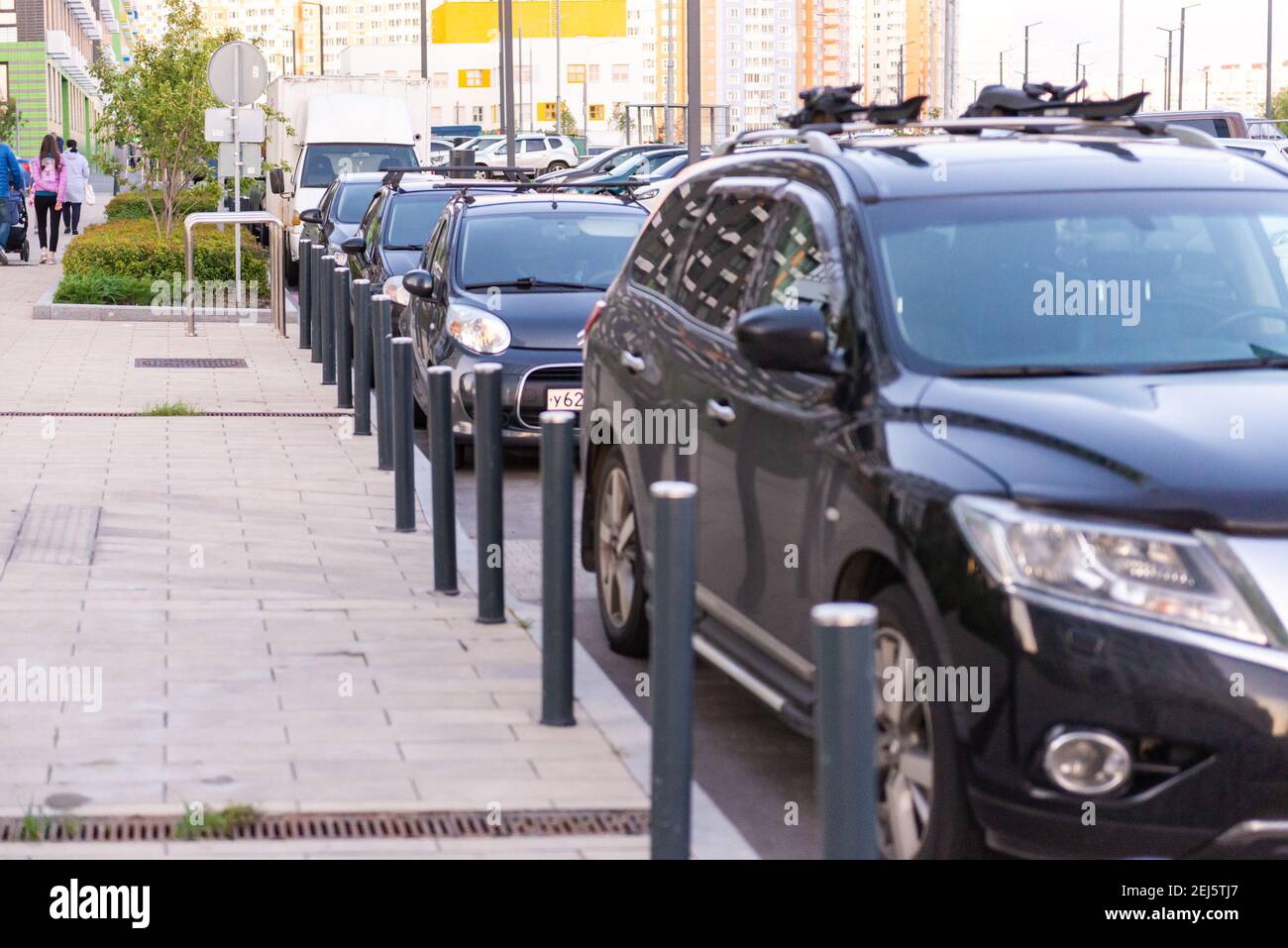Car parking poles. Cars are parked parallel to the houses Stock Photo ...