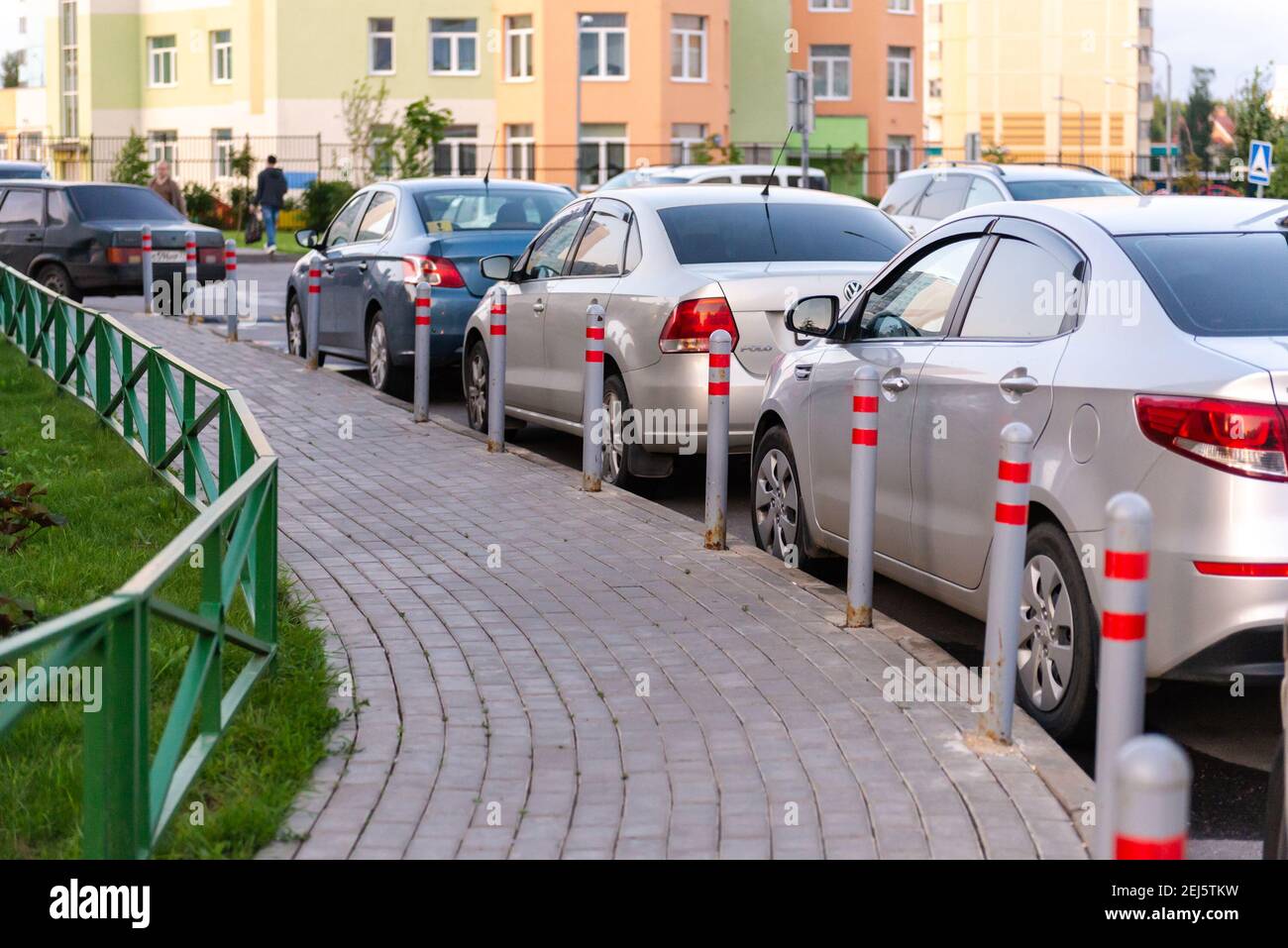 Car parking poles. Cars are parked parallel to the houses Stock Photo ...