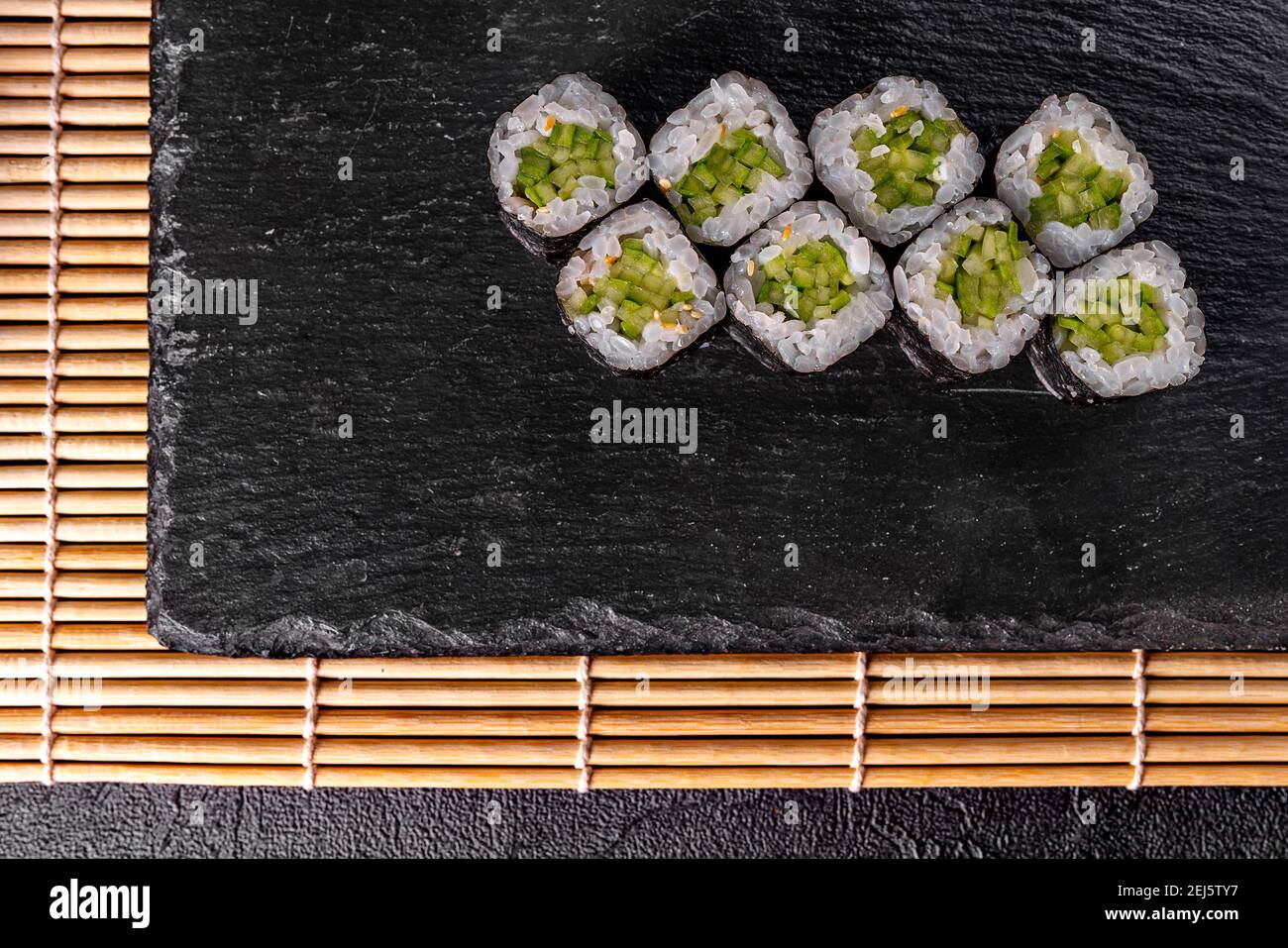 classic Maki roll with cucumber on a black mirror background Stock ...