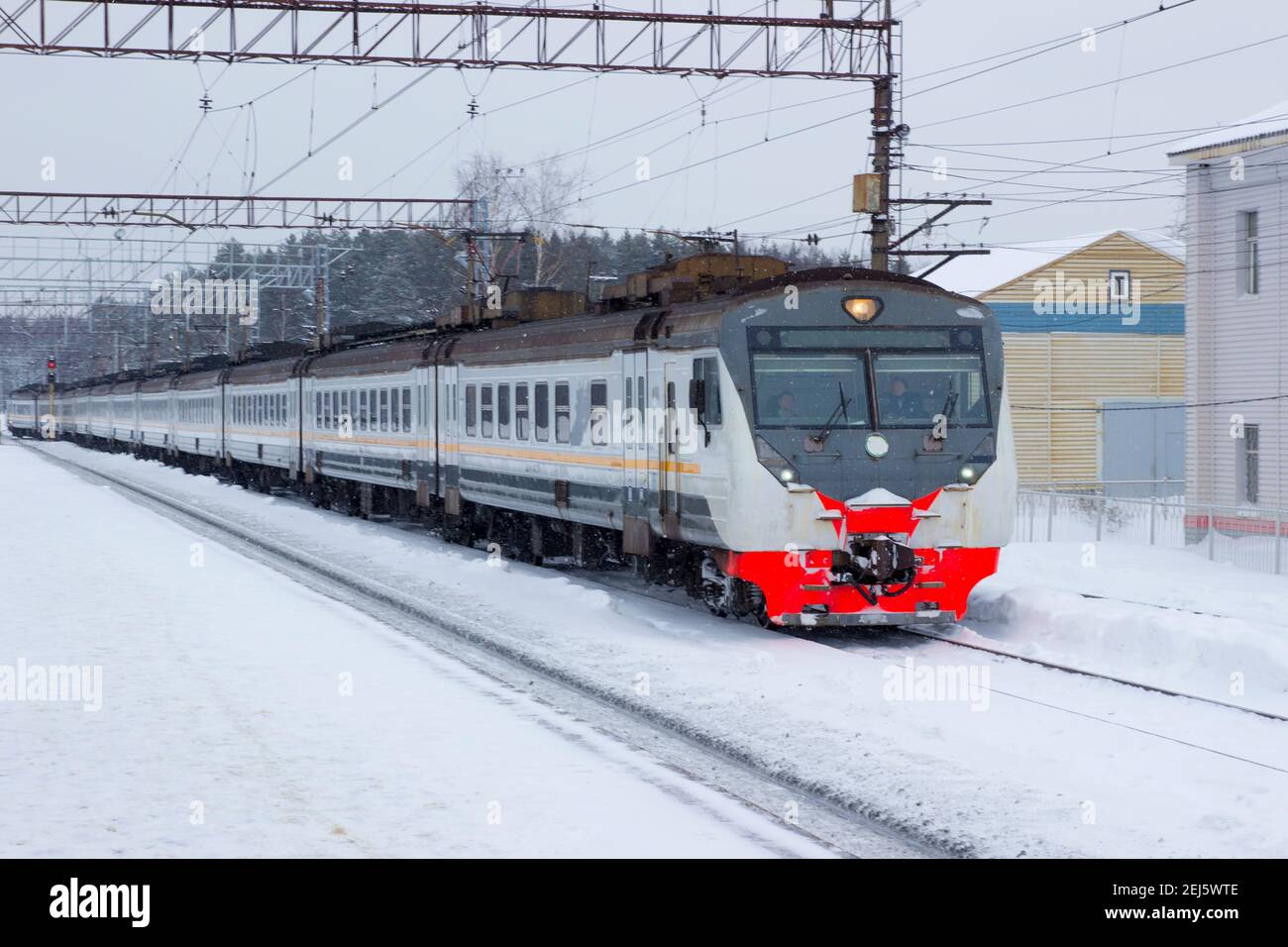 Russian train in the winter. The train pulls up to the station. Winter ...