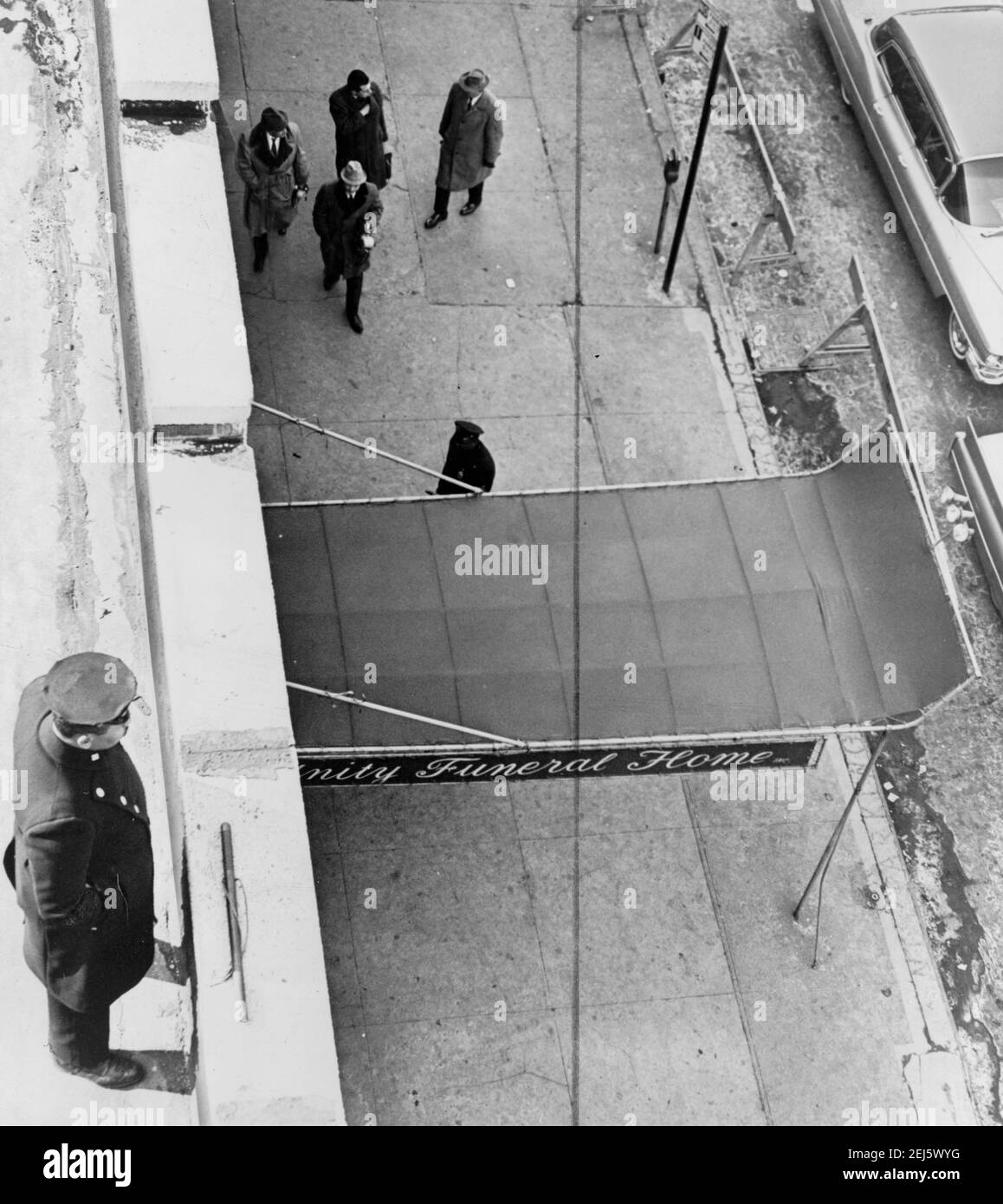 New York City Policeman Maintains Watch From Roof Of Unity Funeral Home Where Body Of Malcolm X