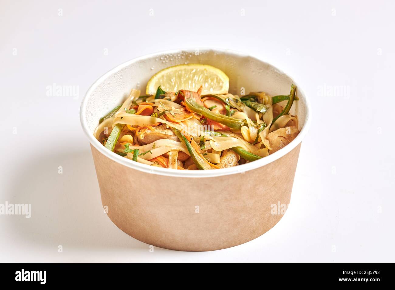 Pad thai noodle cube with chicken zucchini and cashew nuts isolated on ...