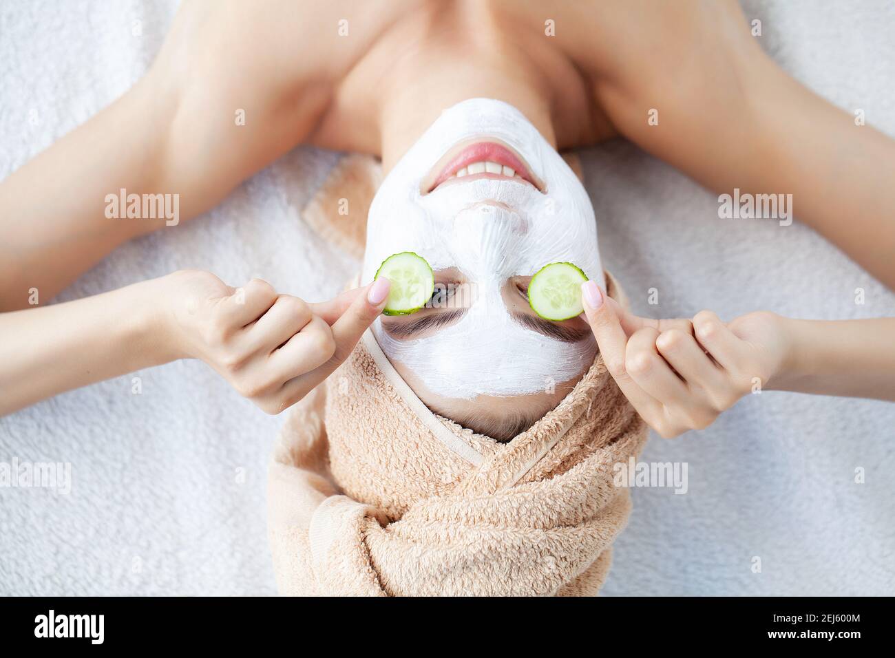 Skin care, woman with beautiful facial skin applying mask on face Stock ...