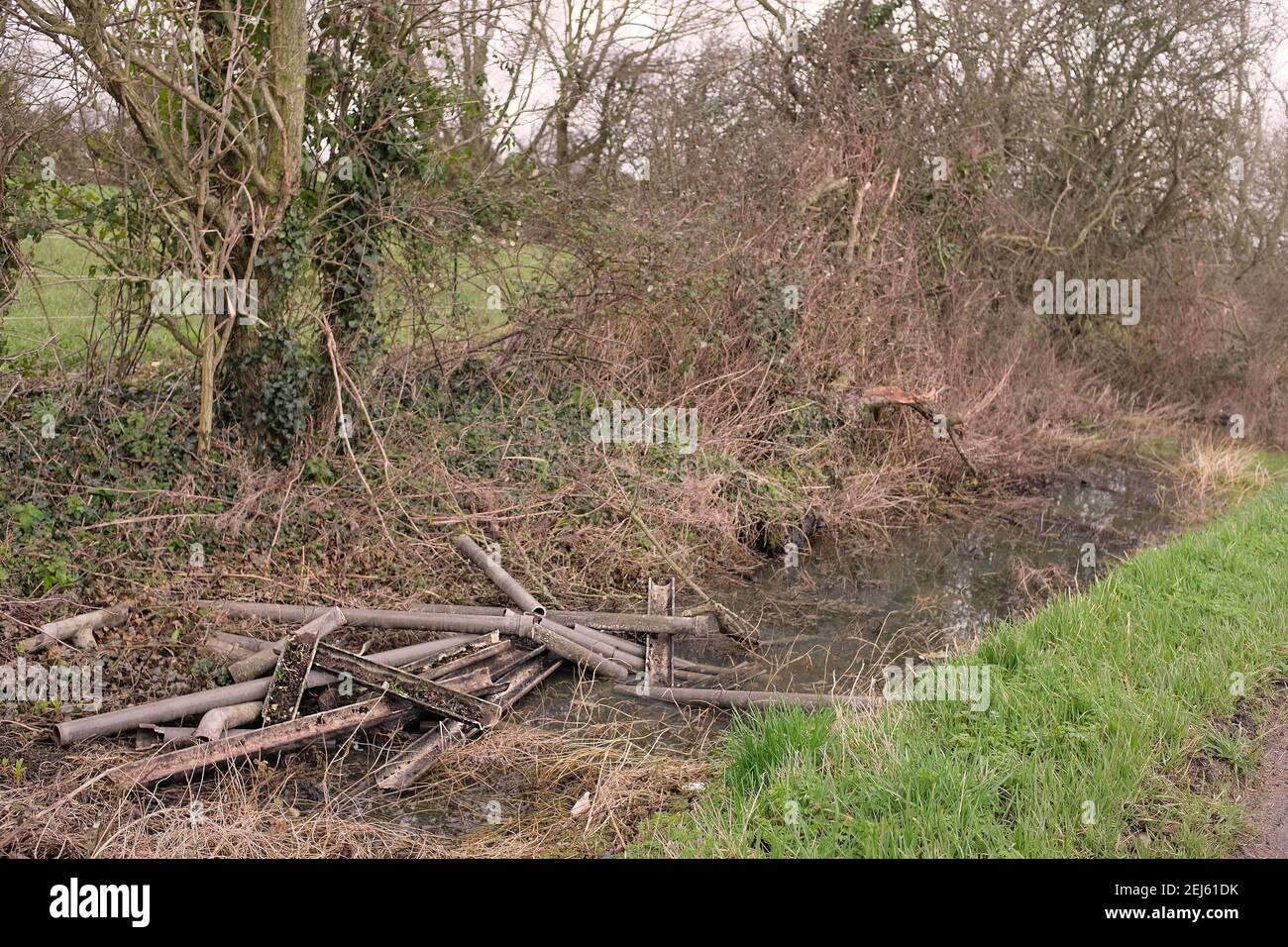 February 2021 - Old pipes and guttering dumped in a ditch, possibly ...